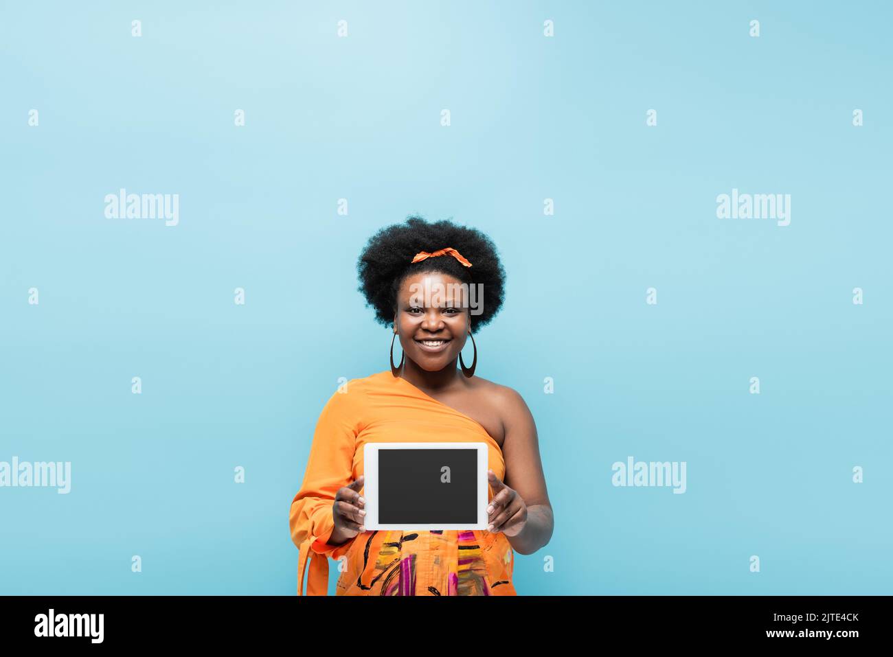 Happy African American Body Positive Woman In Hoop Earrings Holding