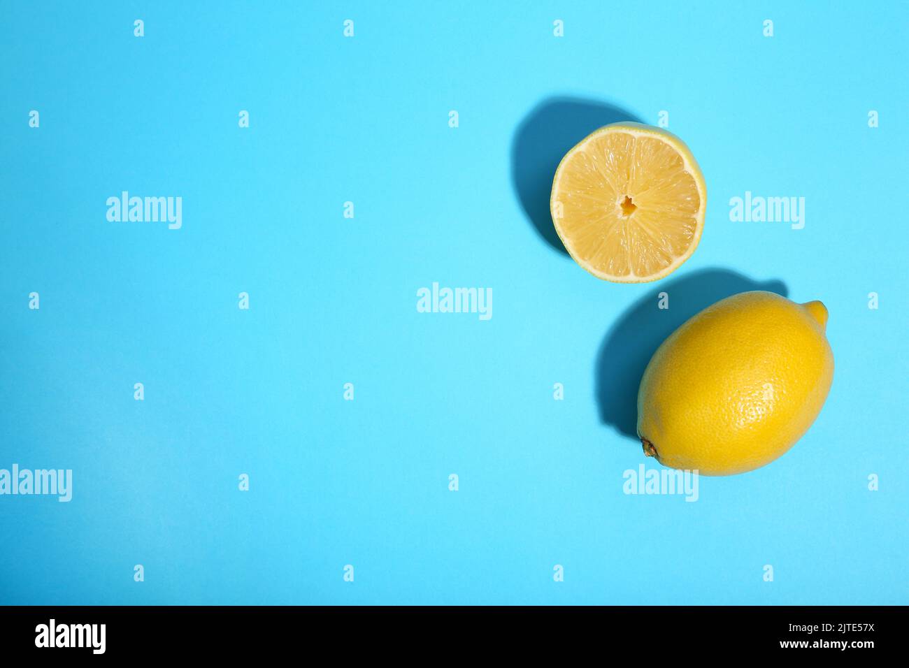 Lemon and half of lemon on blue background. Tropical fruit Stock Photo ...