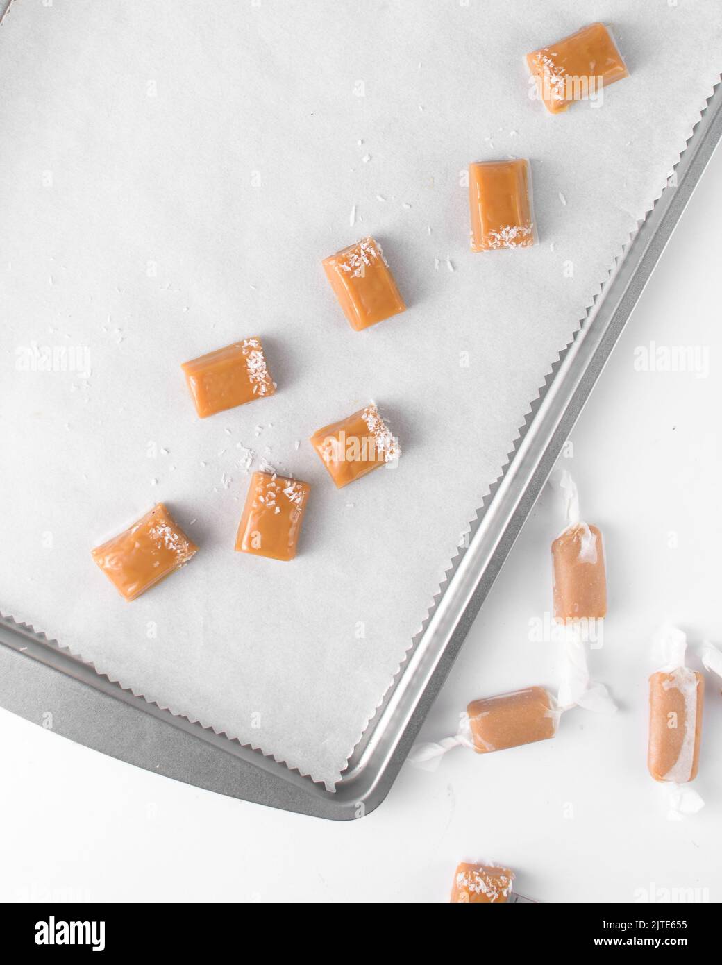 chewy caramels wrapped and unwrapped. Caramel candies in a small bowl ...