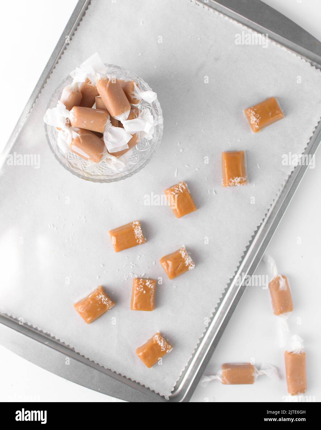 chewy caramels wrapped and unwrapped. Caramel candies in a small bowl ...