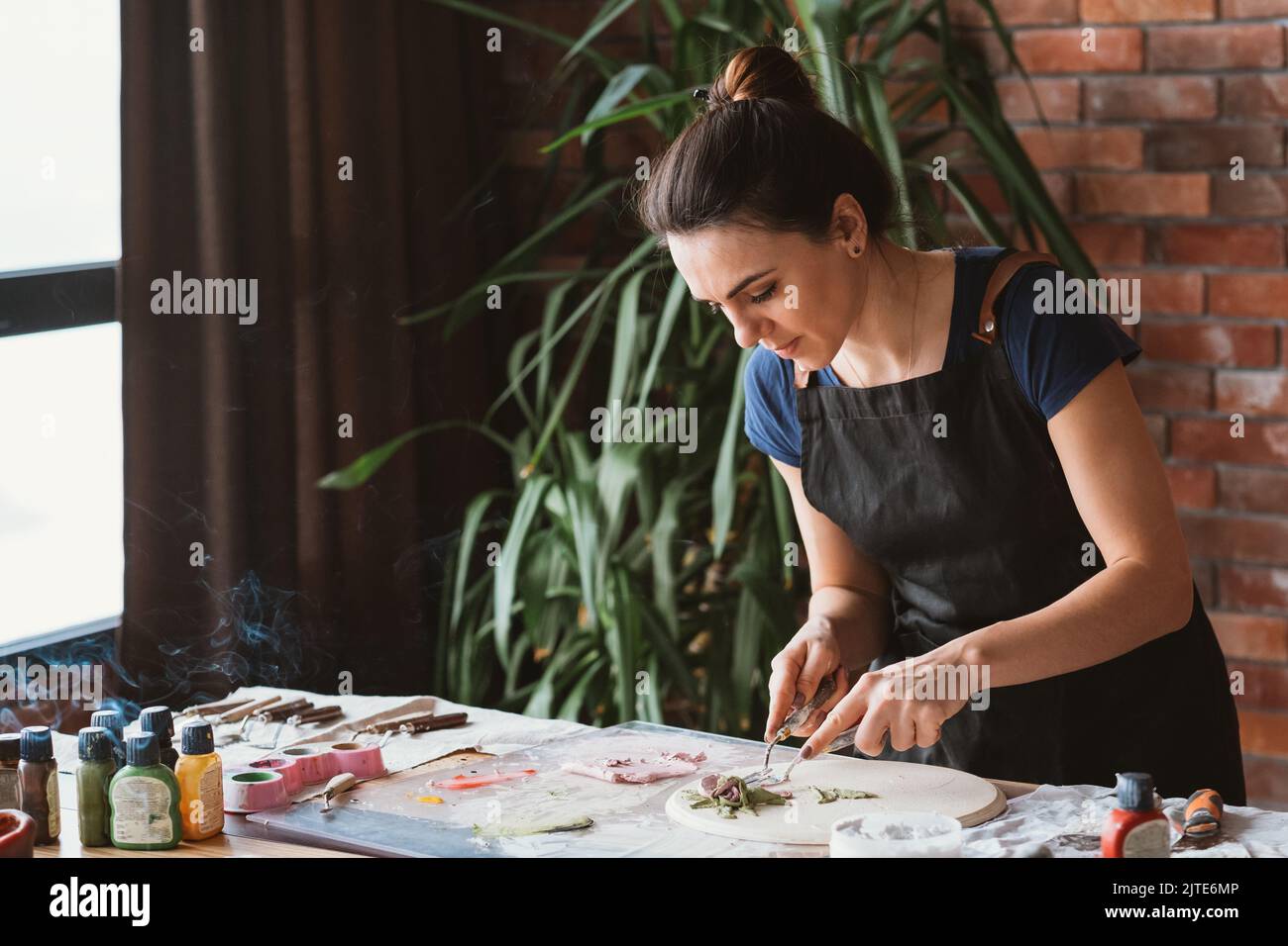 artist studio clay handicraft workplace woman tool Stock Photo - Alamy
