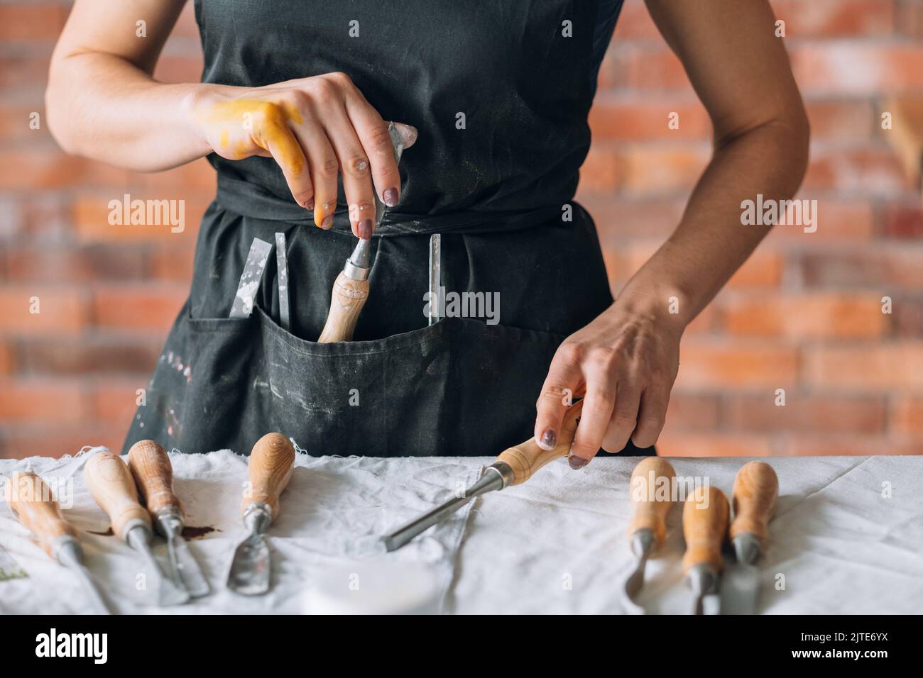 carving tools craft set woman apron chisel Stock Photo - Alamy