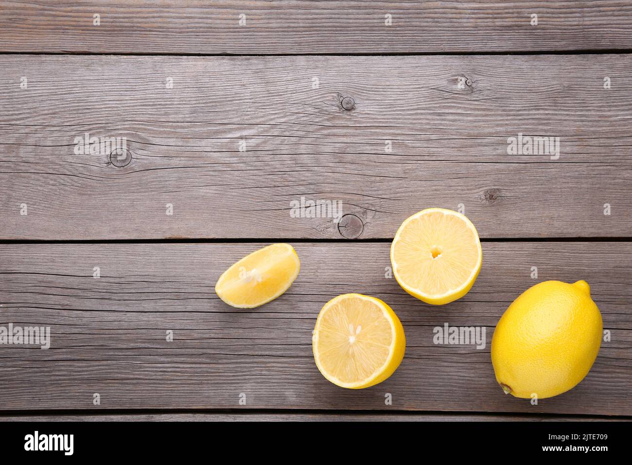 Lemon and half of lemon on grey background. Fresh tropical fruit Stock ...