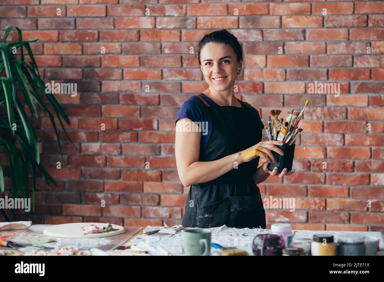 art studio creative woman work artist paintbrushes Stock Photo - Alamy