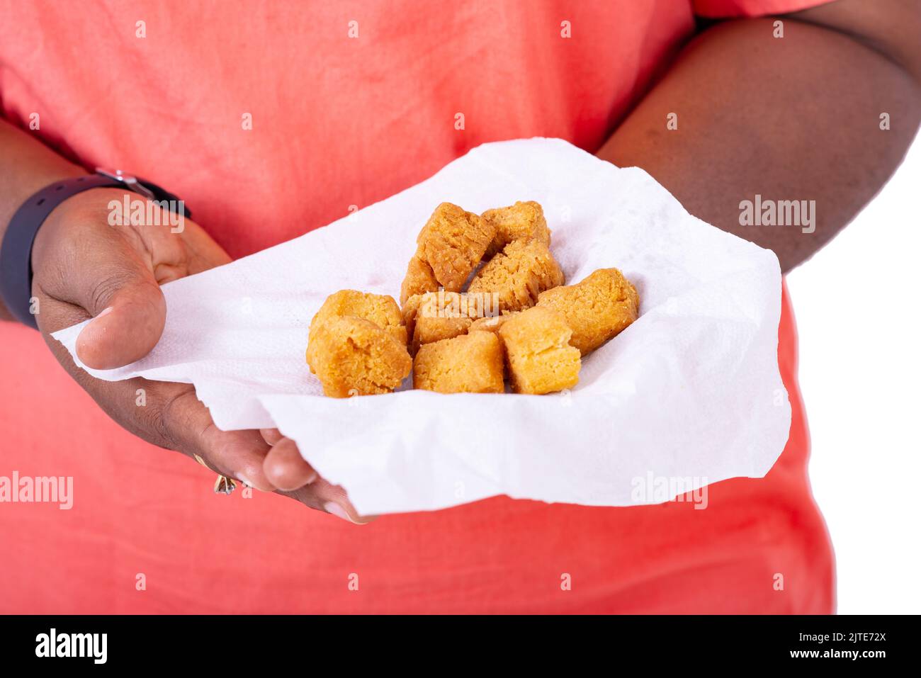a female hand on a white background holding kibble in a tissue Stock ...