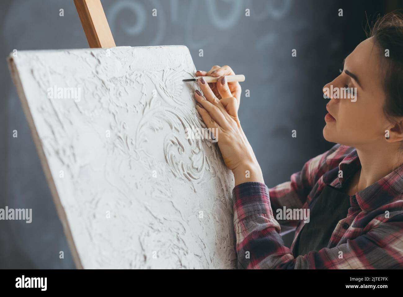 artist relief artwork woman tool concentration Stock Photo - Alamy