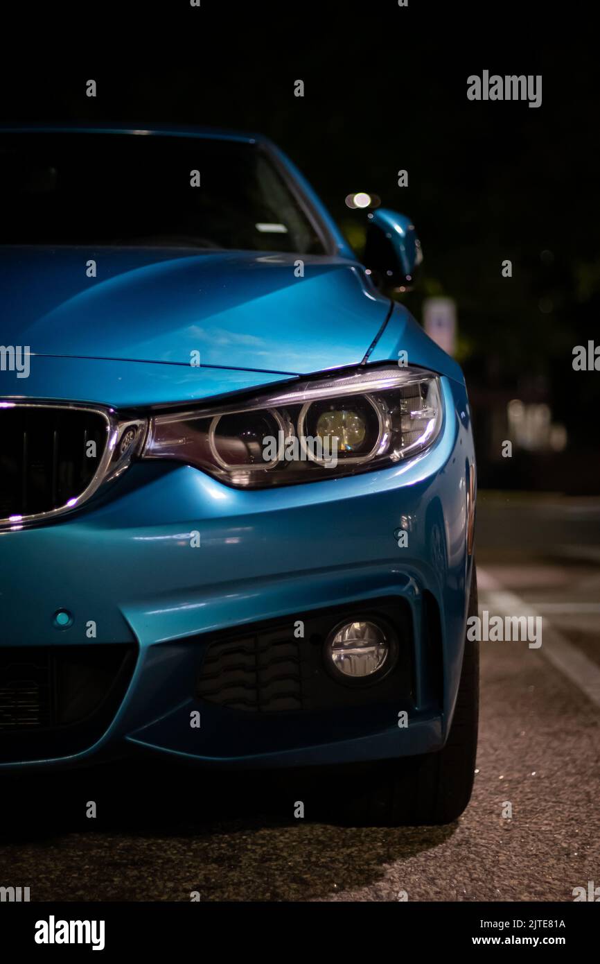 A vertical closeup of a blue modern car headlights Stock Photo - Alamy