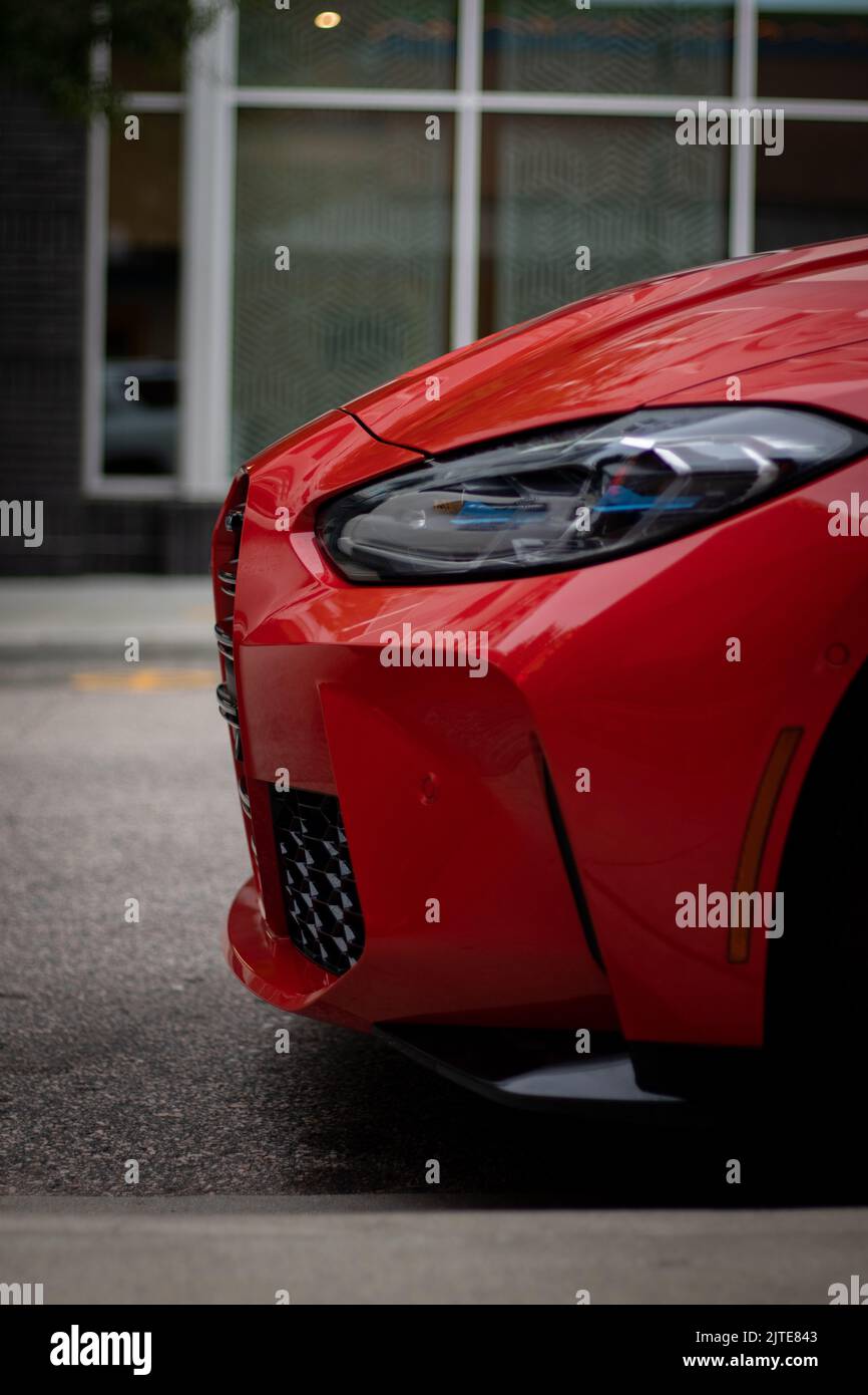 A vertical closeup of a red modern car headlights Stock Photo - Alamy