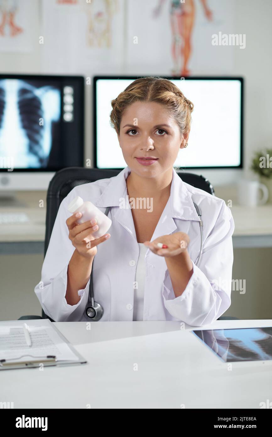 Positive young doctor prescribing medicine Stock Photo - Alamy