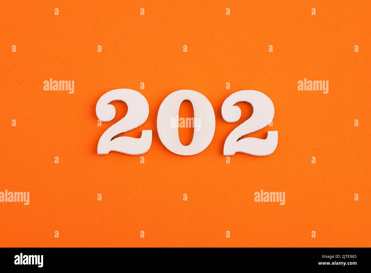 White wooden number 202 on eva rubber orange background Stock Photo - Alamy