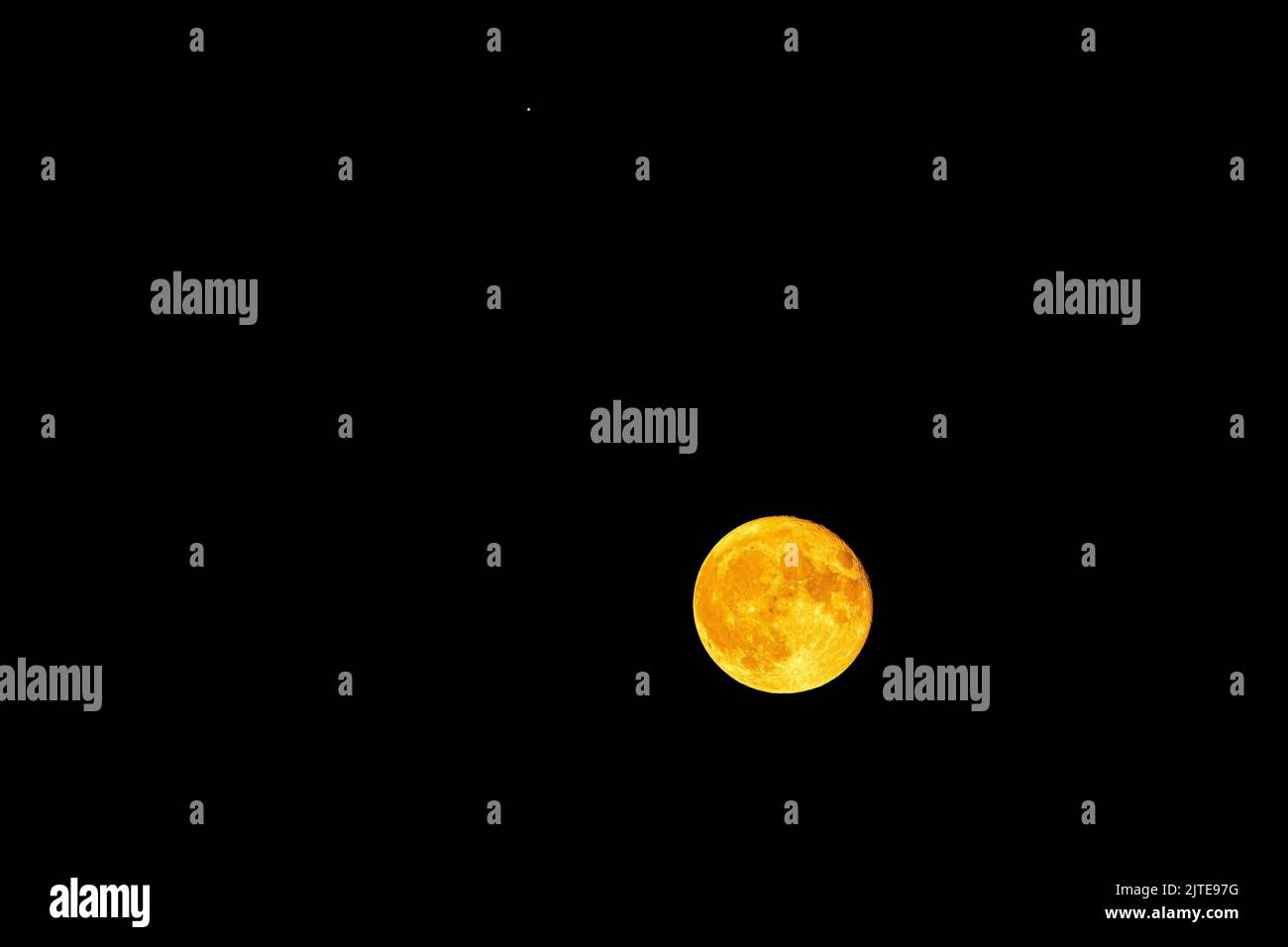 The illuminated yellow full moon isolated in the dark sky Stock Photo ...