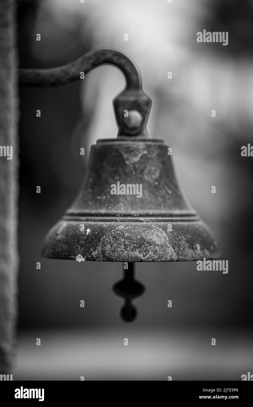 A vertical greyscale shot of a rusty bell Stock Photo - Alamy