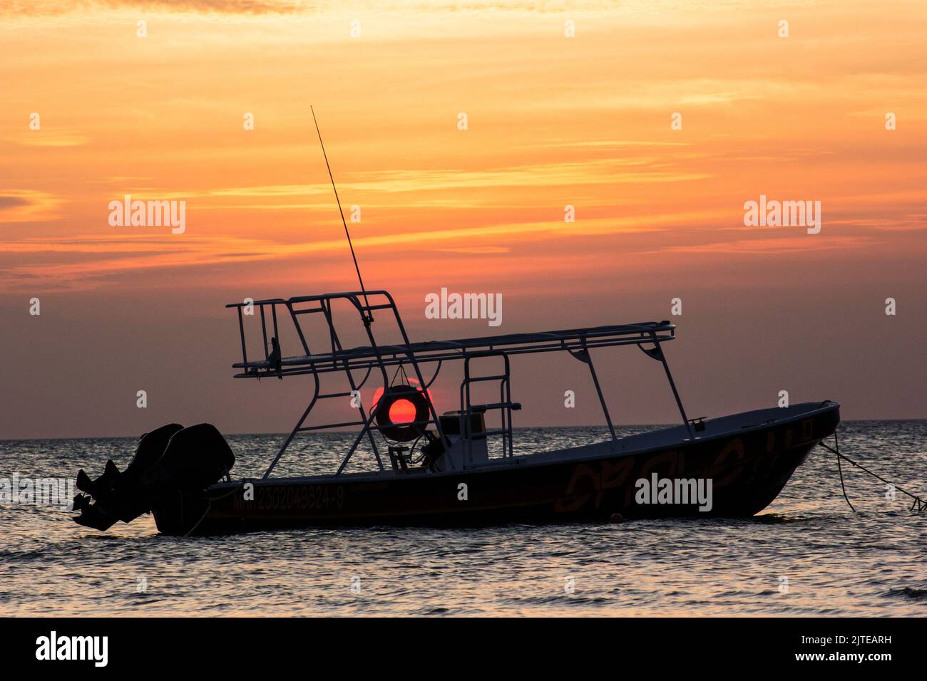 Boat in the sunset at holbox island in Mexico Stock Photo - Alamy