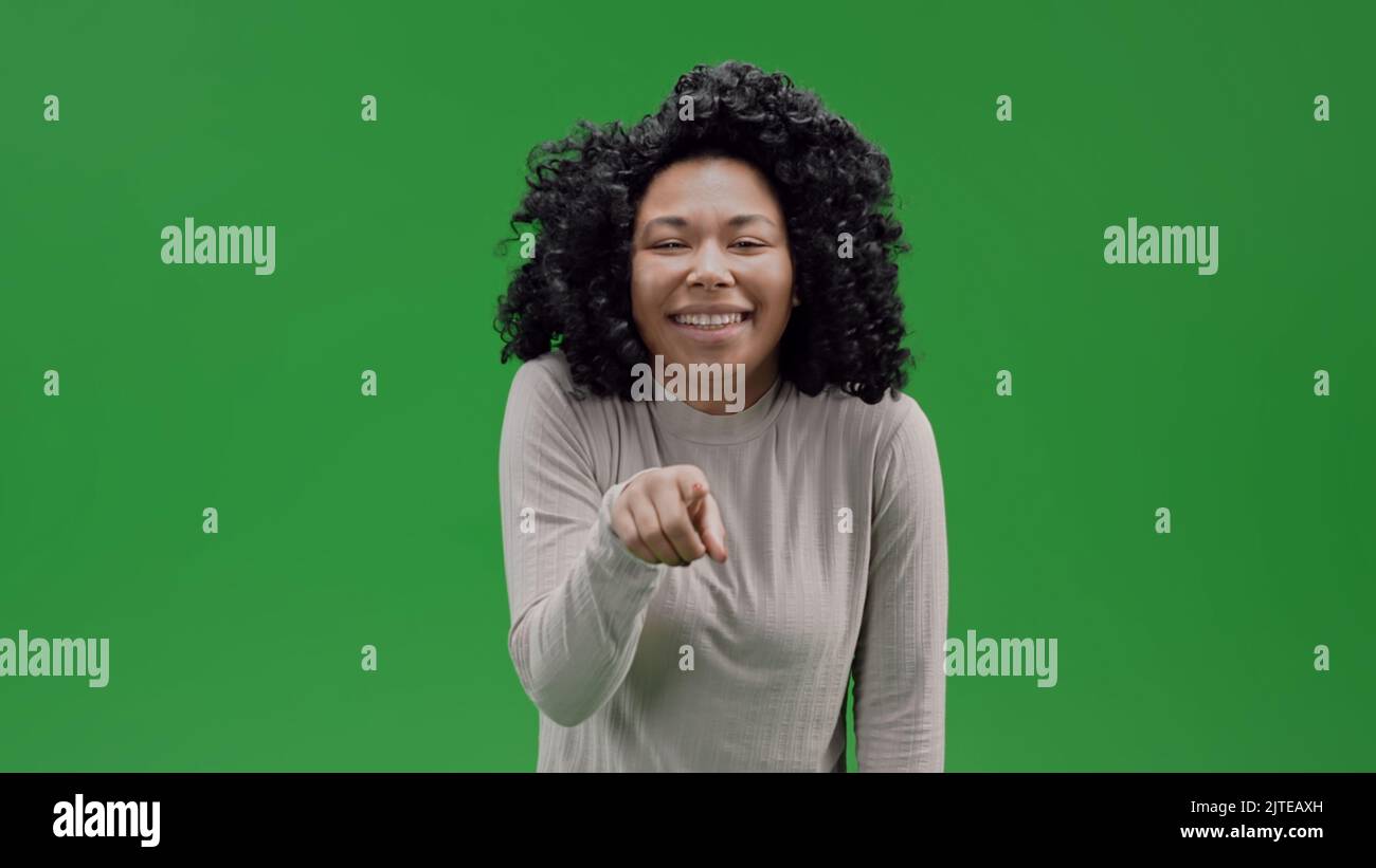 An African woman with curly hair showing index finger towards in chroma ...