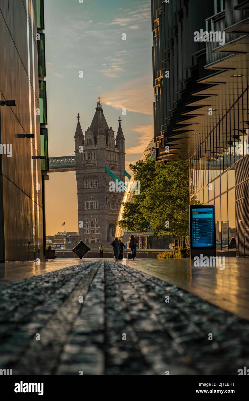 Tower Bridge seen through More London Riverside alleyway at sunrise ...