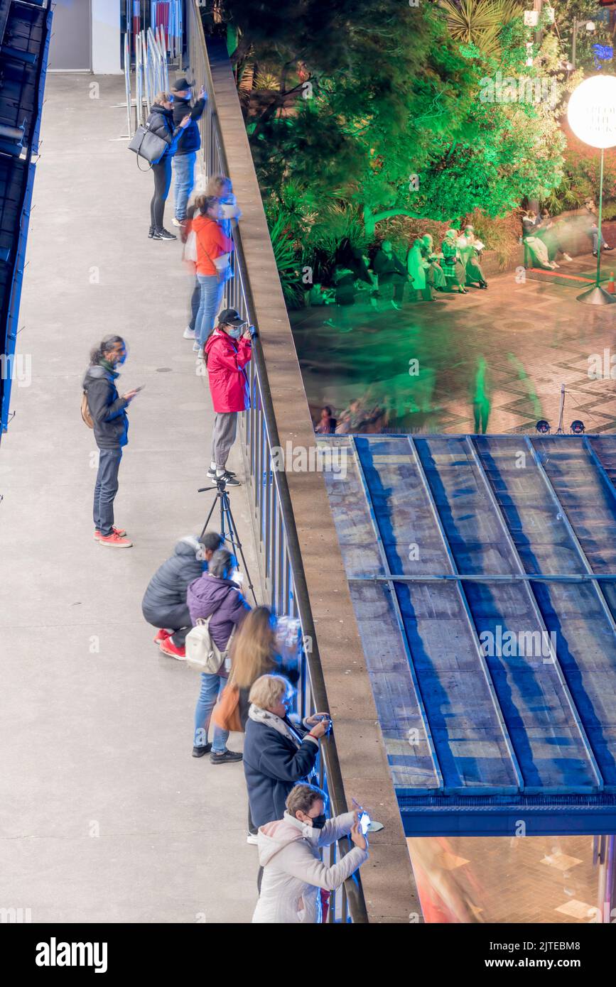 Photographers with cameras and phones line up along the railway ...