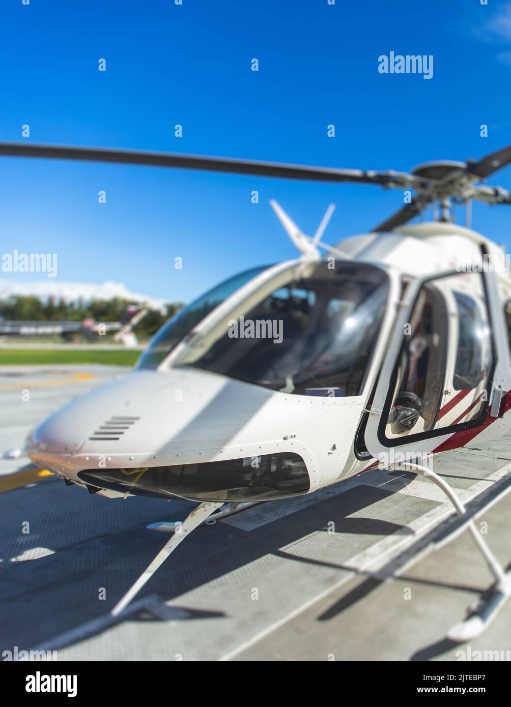Civil white helicopter getting ready to fly take off, commercial ...