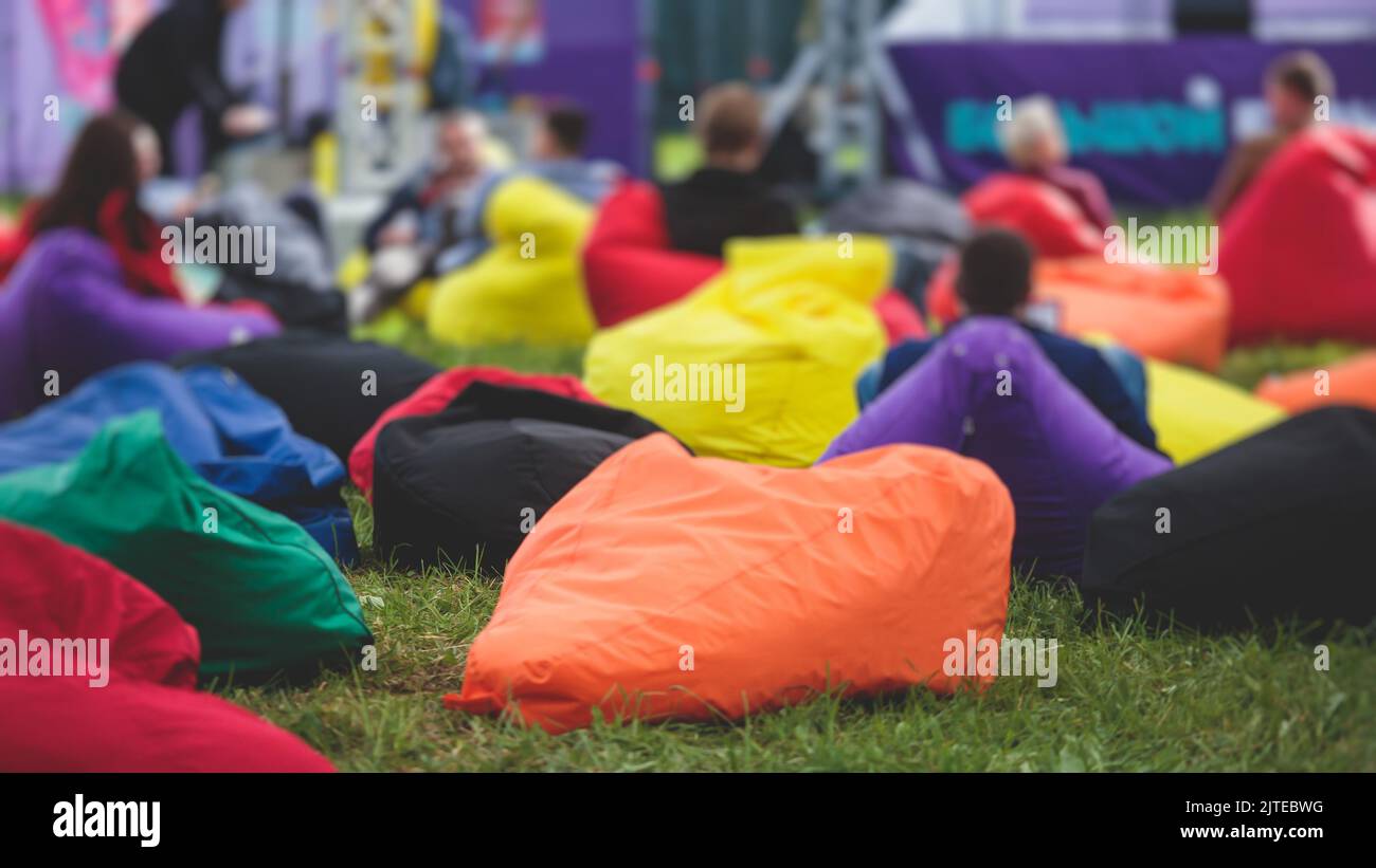 Audience at the open air venue listens to lecturer, people crowd on a ...