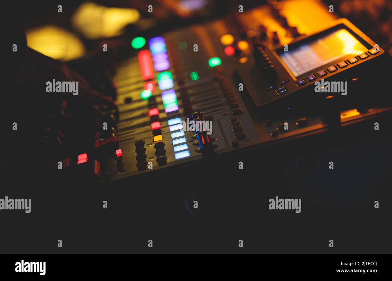 View of lighting technician operator working on mixing console ...