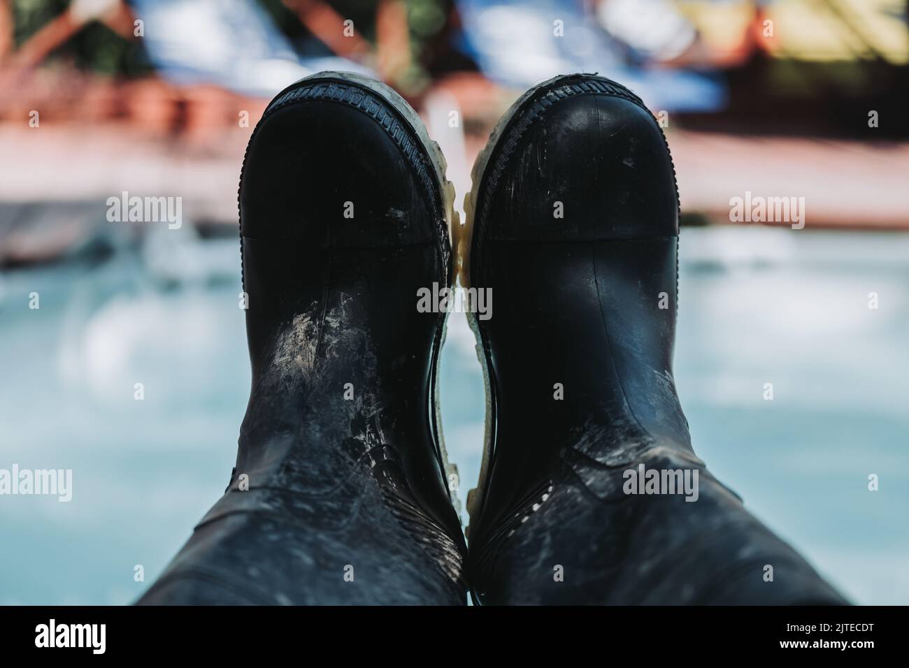 A closeup shot of black hiking rainboots in the Peruvian Amazonia ...