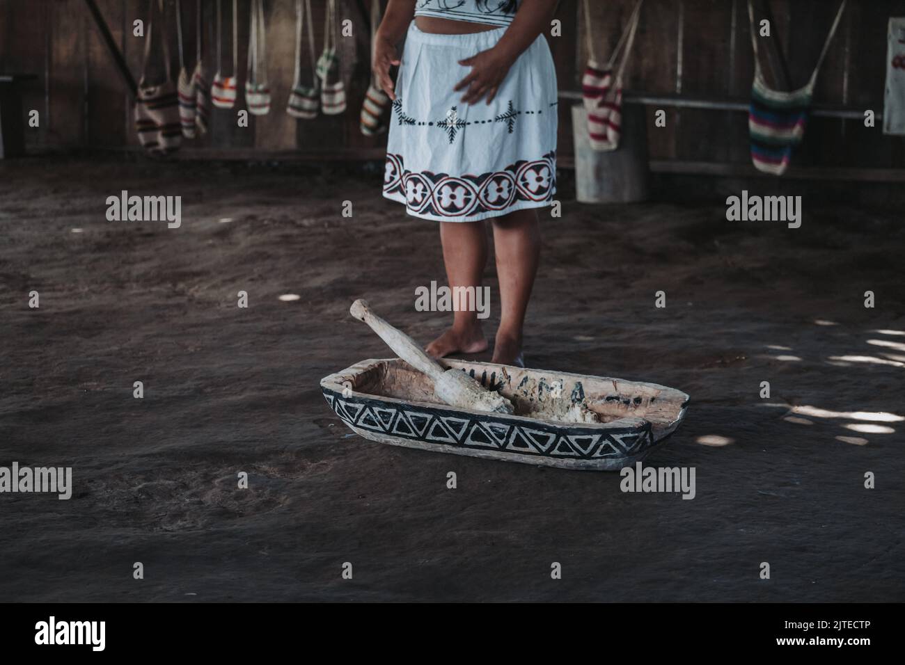 A female in traditional clothing with relics in the Peruvian Amazonia ...