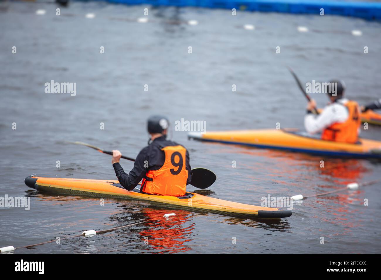 Canoe polo match, two teams play kayak polo game outdoor competition in ...