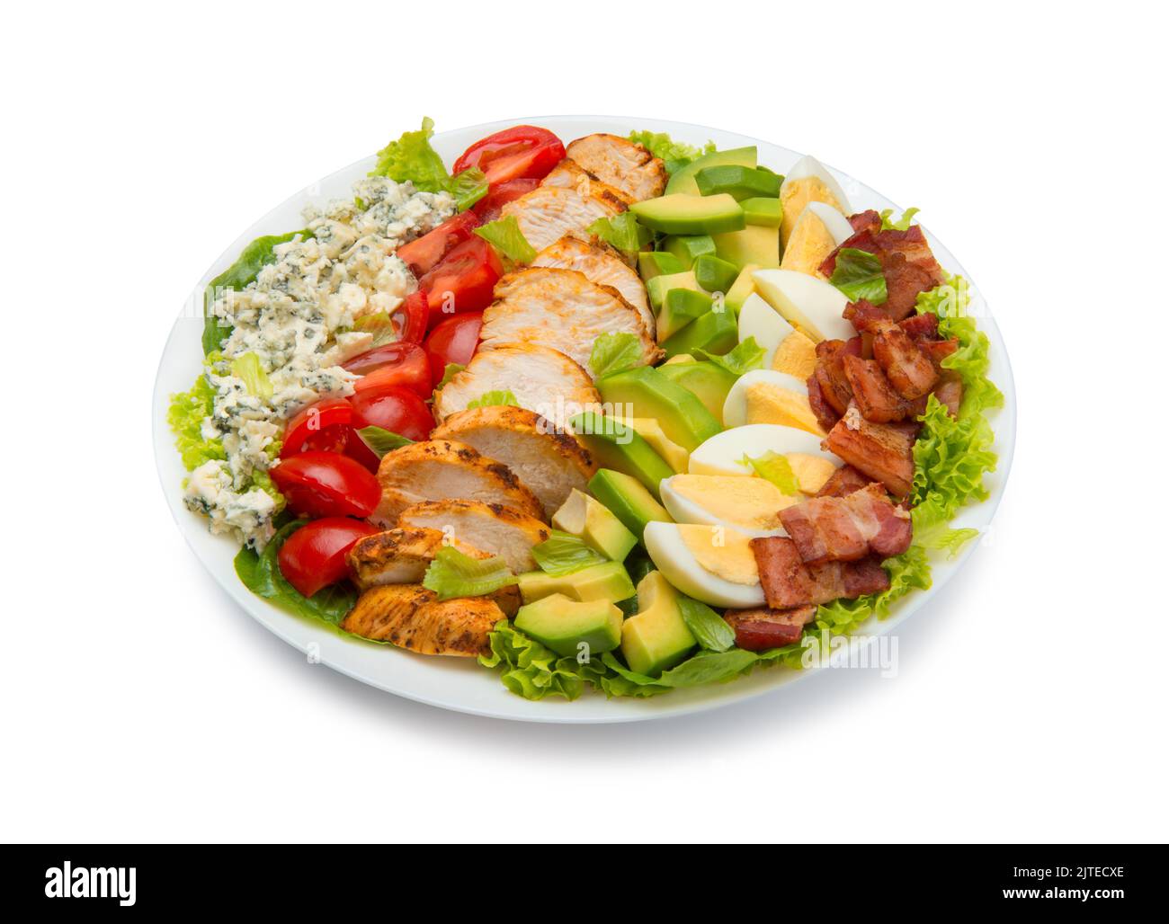 Cobb salad of romain lettuce, slices bacon, avocado, chicken, tomato ...