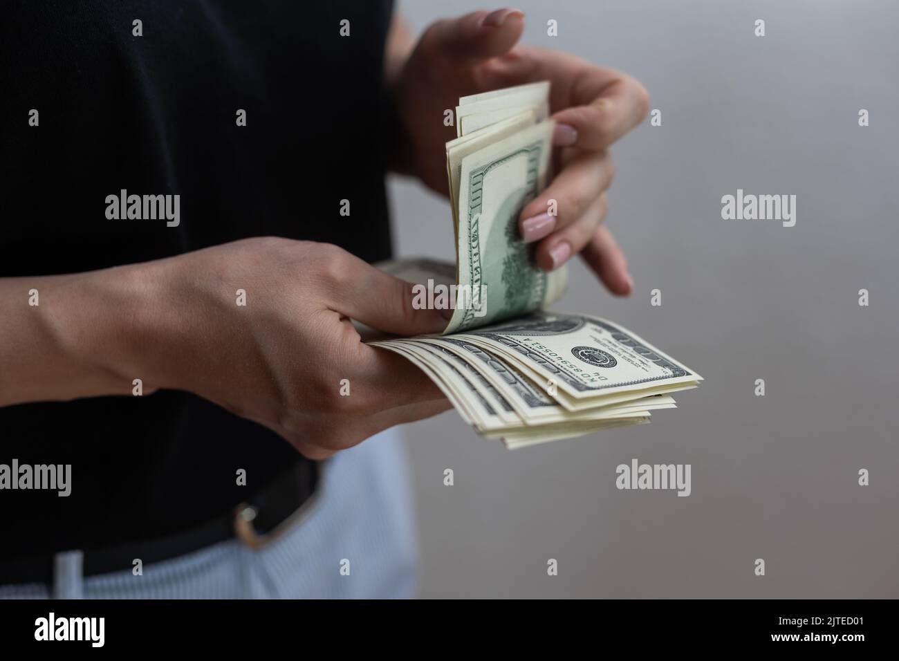 Business woman counting us dollars hi-res stock photography and images - Alamy