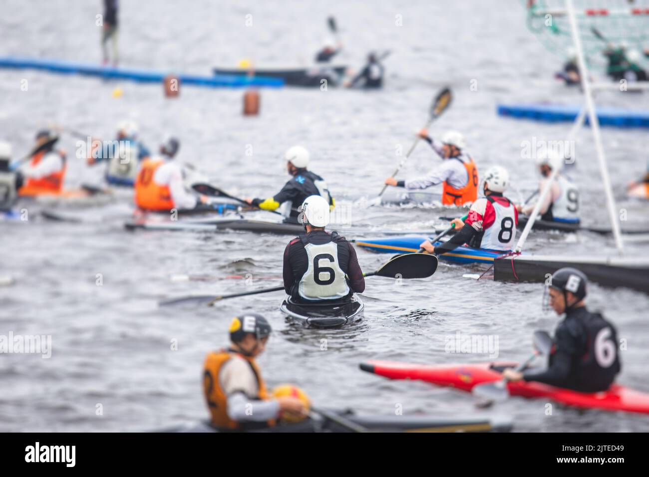 Canoe polo match, two teams play kayak polo game outdoor competition in ...