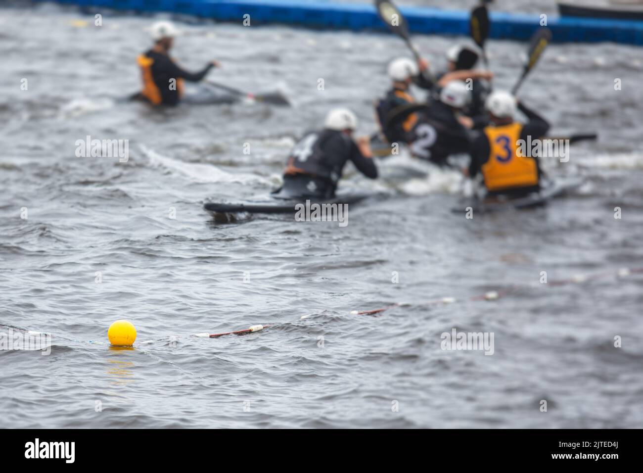 Canoe polo match, two teams play kayak polo game outdoor competition in ...