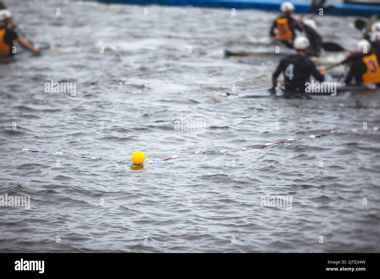 Canoe polo match, two teams play kayak polo game outdoor competition in ...