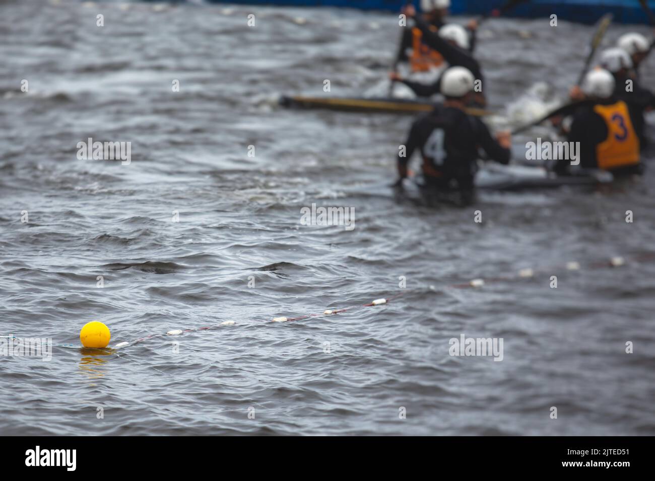 Canoe polo match, two teams play kayak polo game outdoor competition in ...