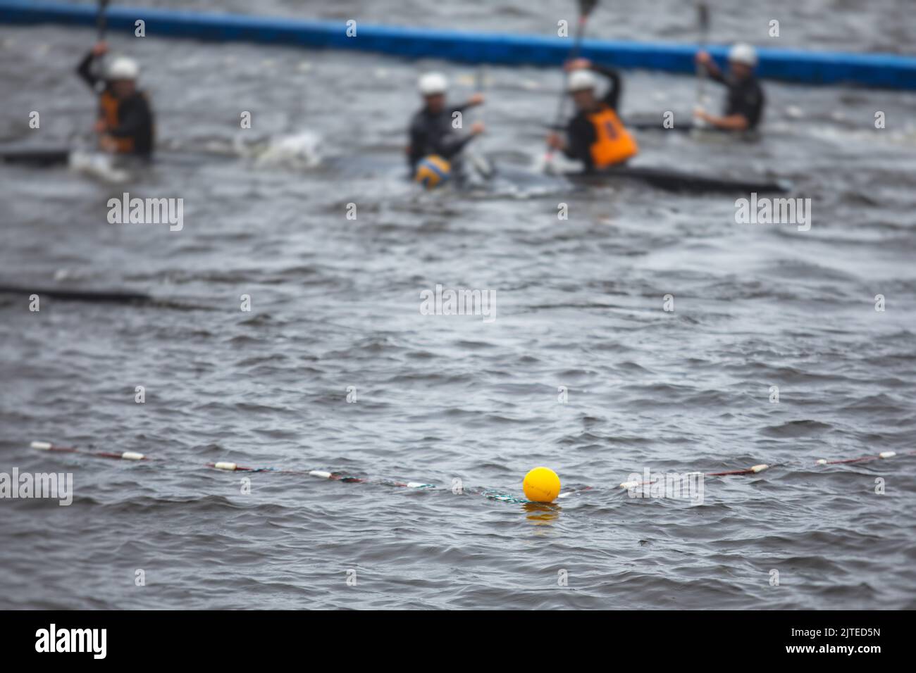 Canoe polo match, two teams play kayak polo game outdoor competition in ...