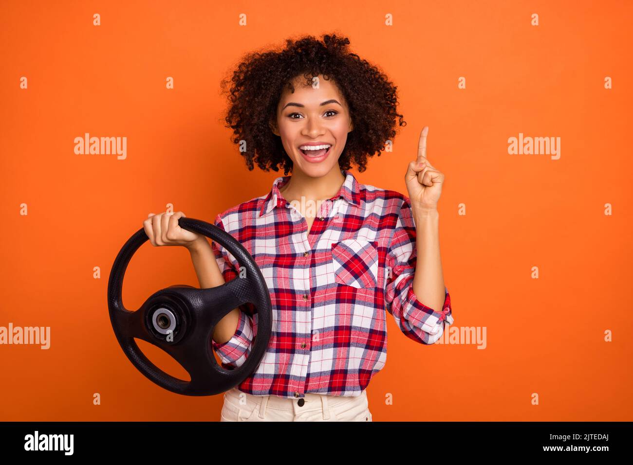 Portrait of attractive trendy cheerful girl holding steering wheel ...