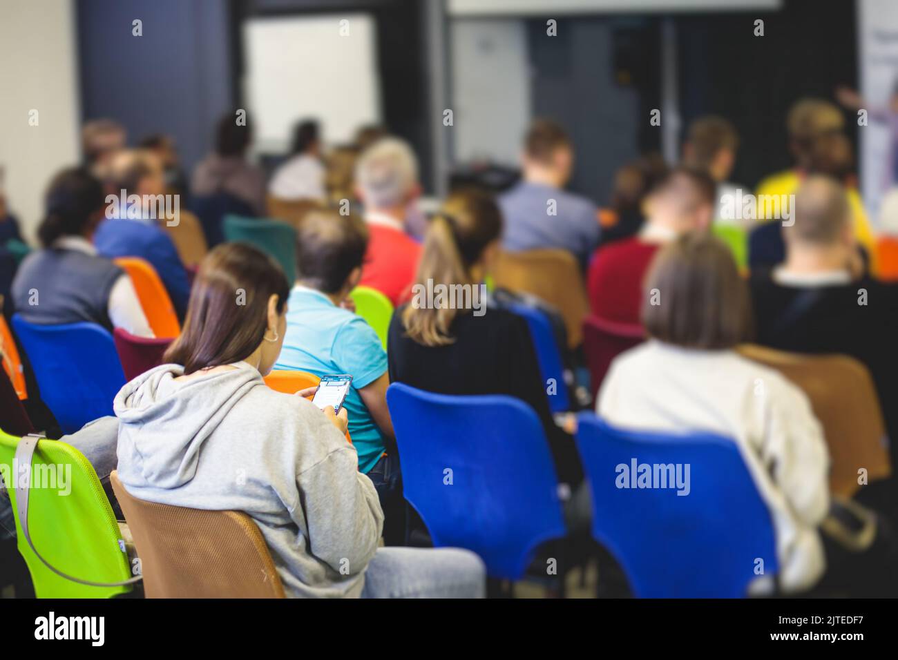Audience at the conference hall venue listens to lecturer, people on a ...