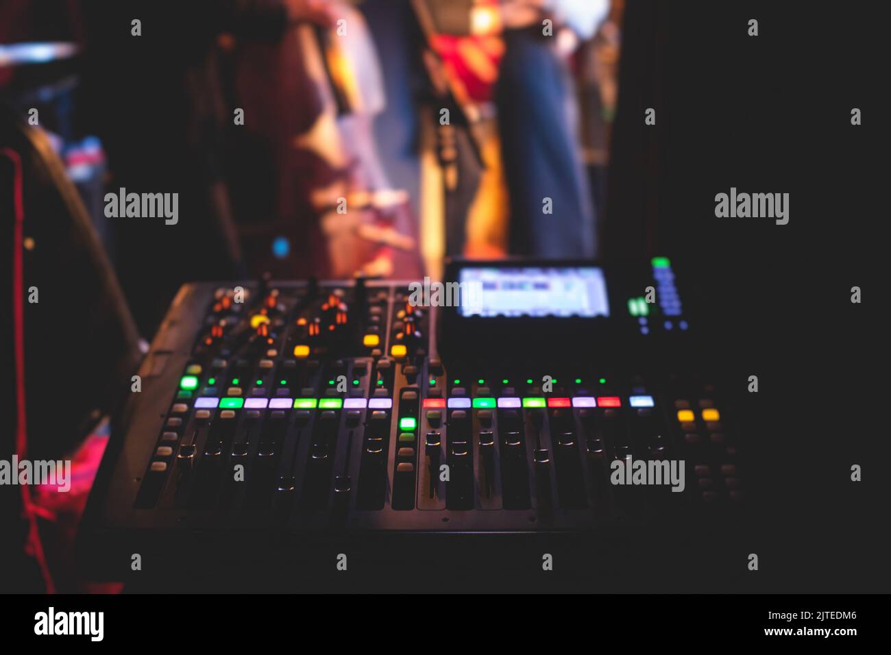 View of lighting technician operator working on mixing console ...
