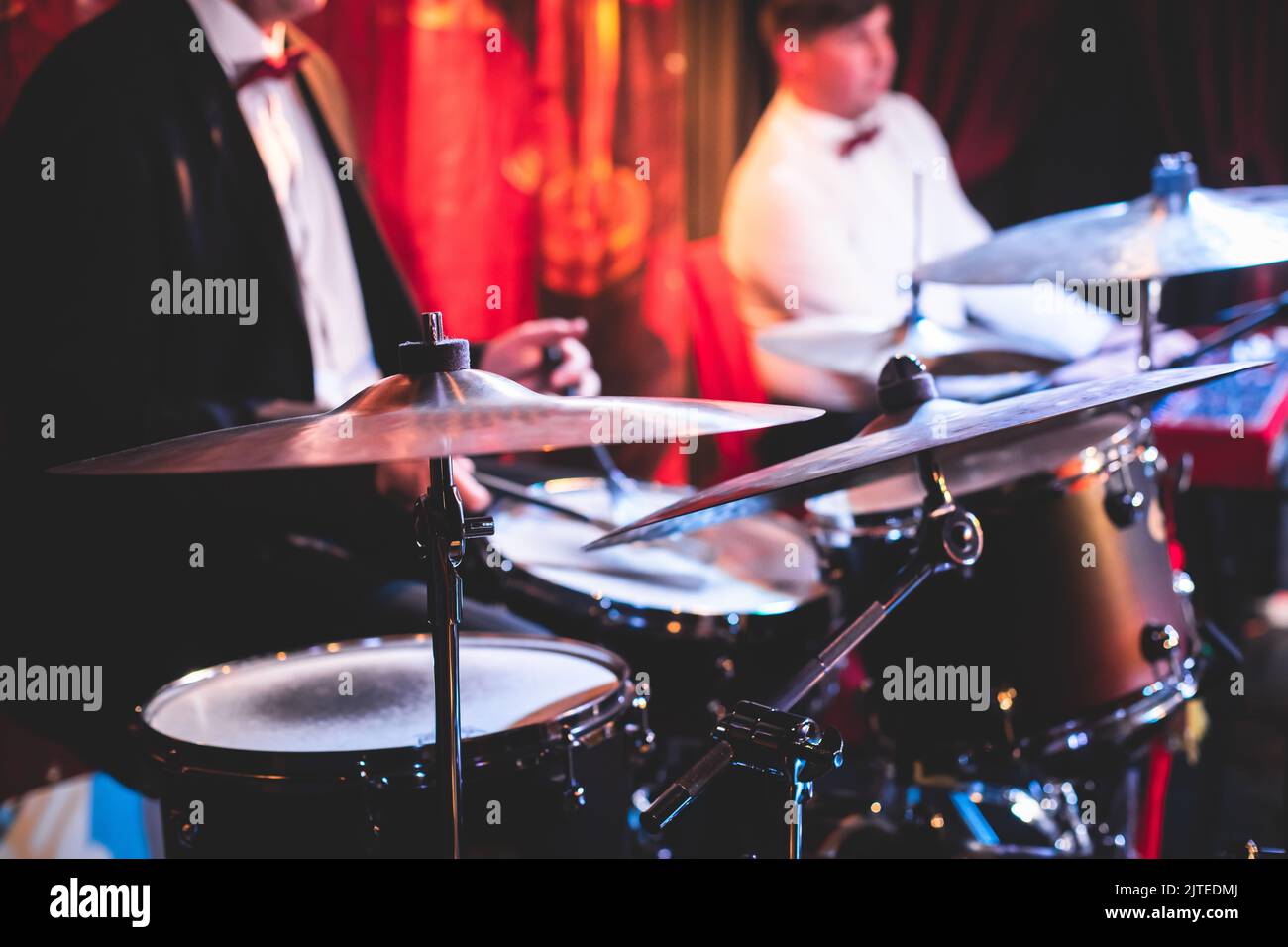 Drummer percussionist performing on a stage with drum set kit during ...