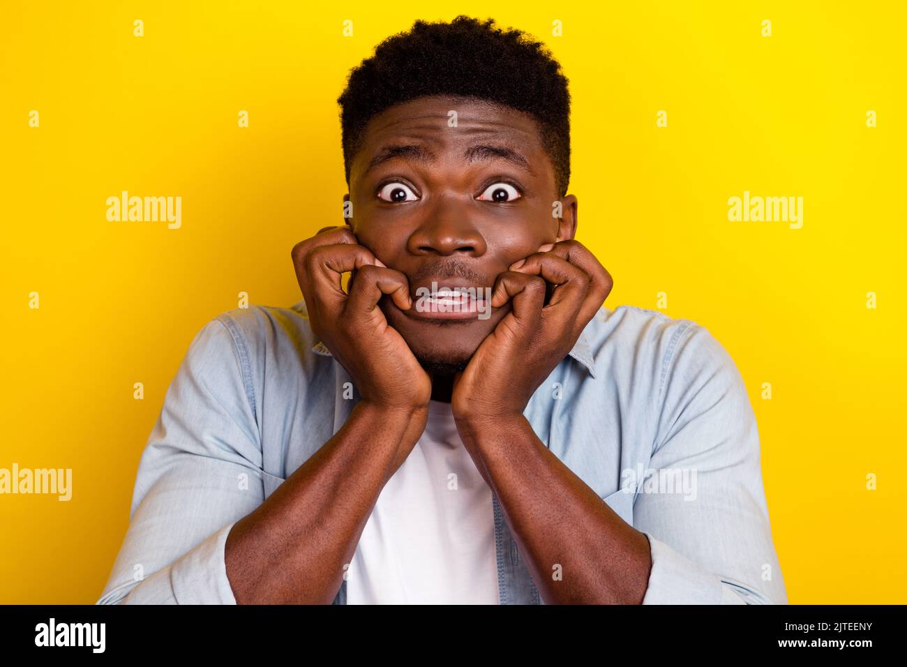 Portrait of shocked guy look nightmare bite nails feel scared isolated ...