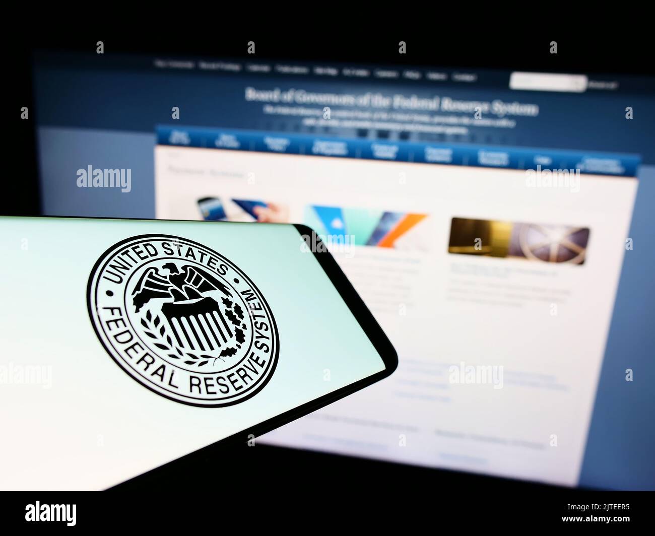 Mobile phone with seal of United States Federal Reserve System (Fed) on ...