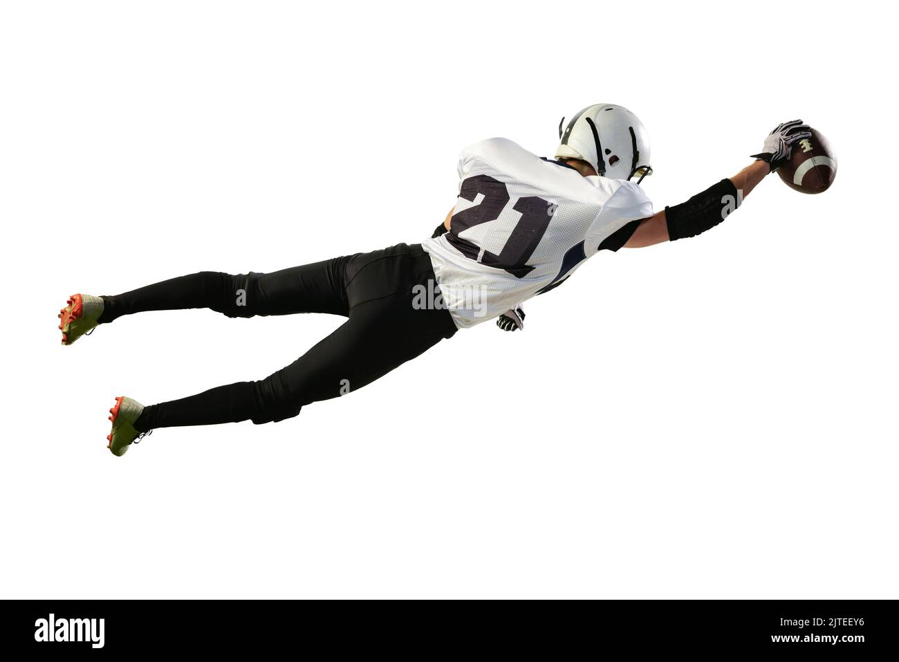 Portrait of american football player in motion, catching ball in a jump ...