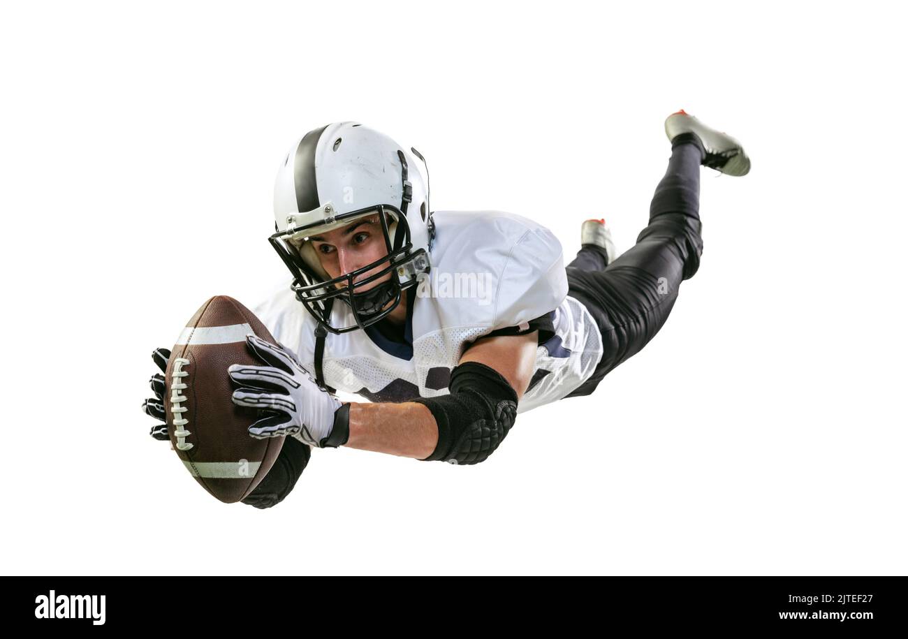 Portrait of american football player in motion, catching ball in a jump ...