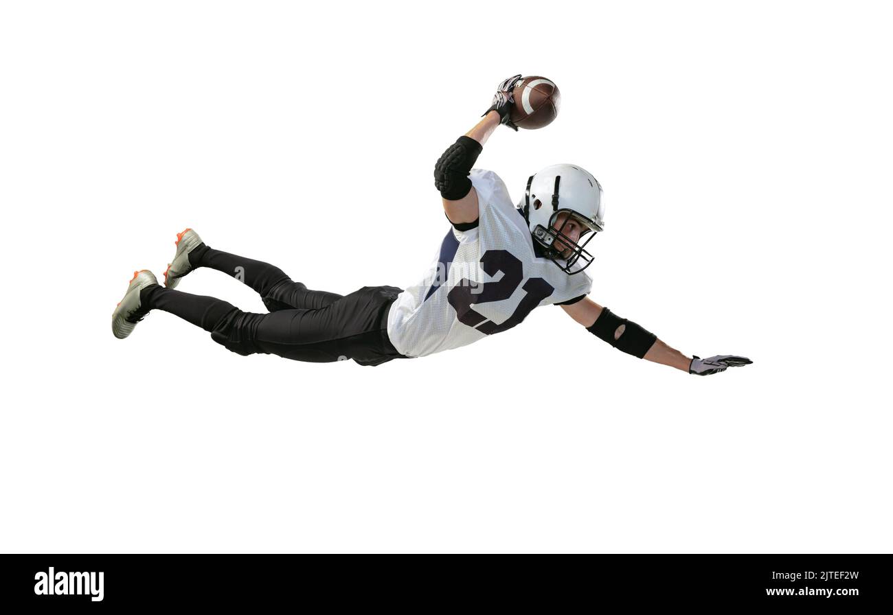Portrait of american football player in motion, catching ball in a jump ...