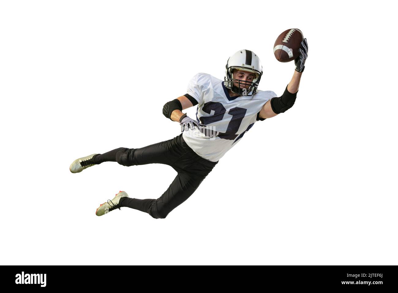Portrait of american football player in motion, catching ball in a jump ...