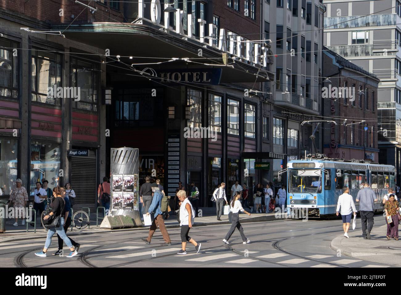 Trams and pedestrians in the street of Storgata the home of ...
