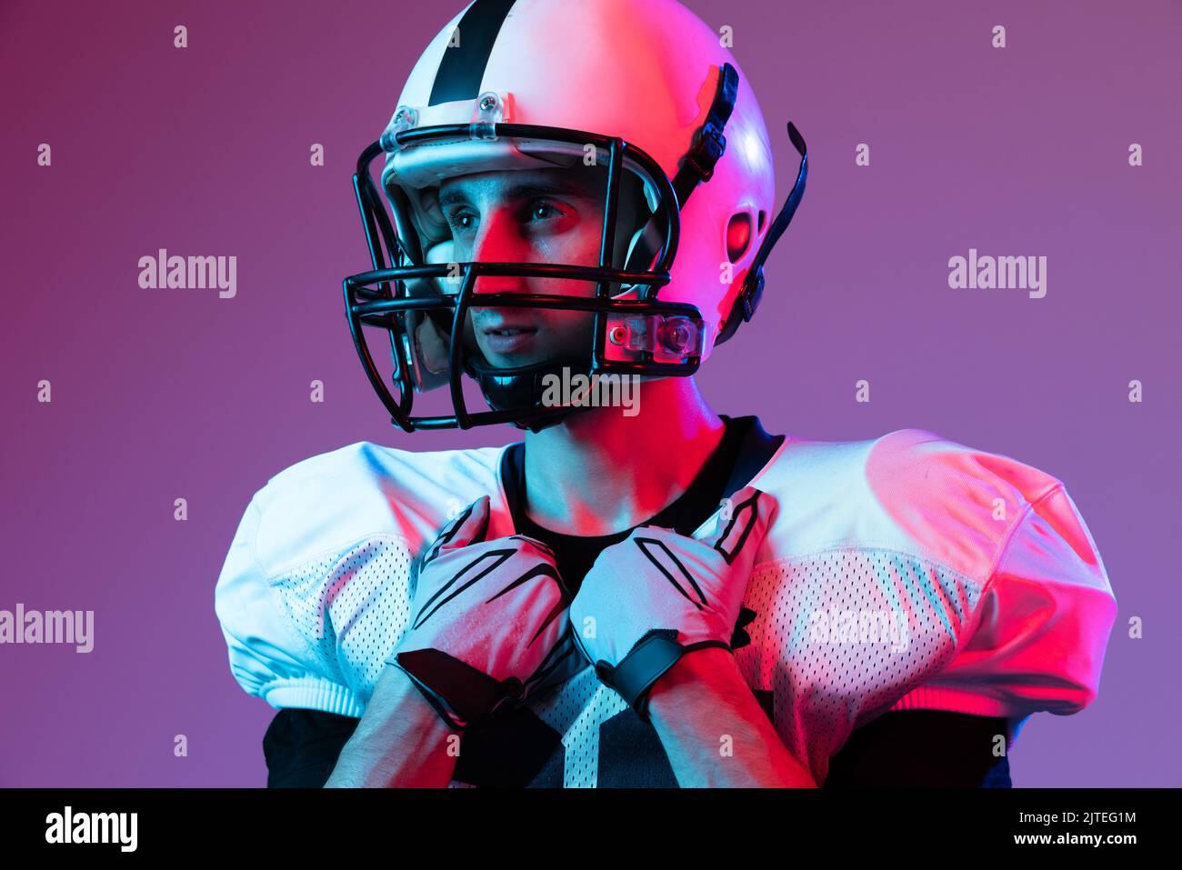 Close-up portrait of young man, american football player in helmet ...