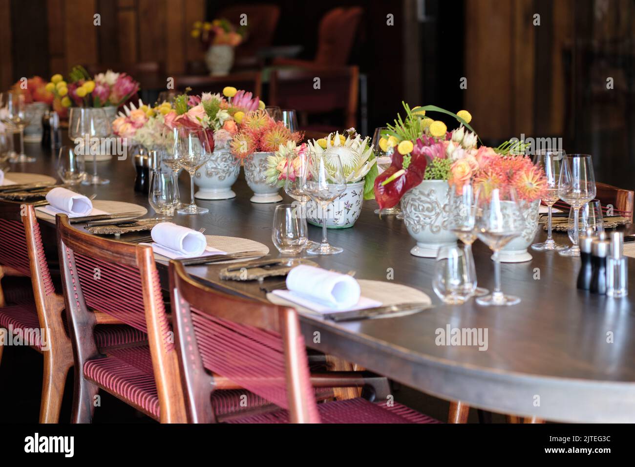 A closeup shot of a beautifully set table with flowers Stock Photo - Alamy