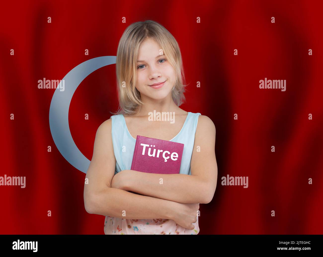 Young smiling girl and textbook with inscription turkish in turkish ...