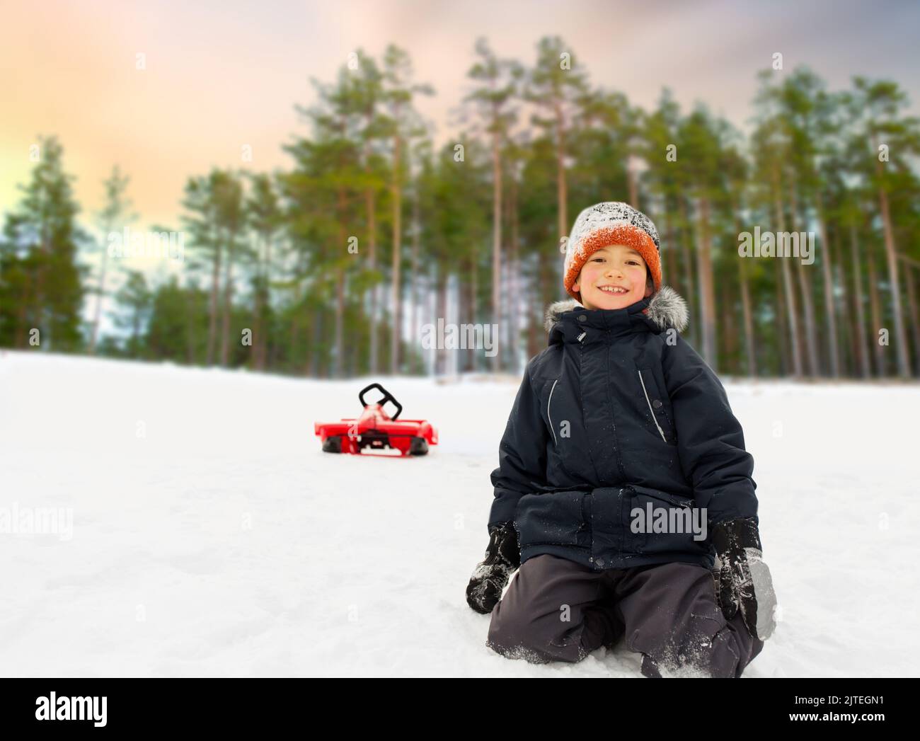 happy boy and sled on snow hill in winter Stock Photo - Alamy