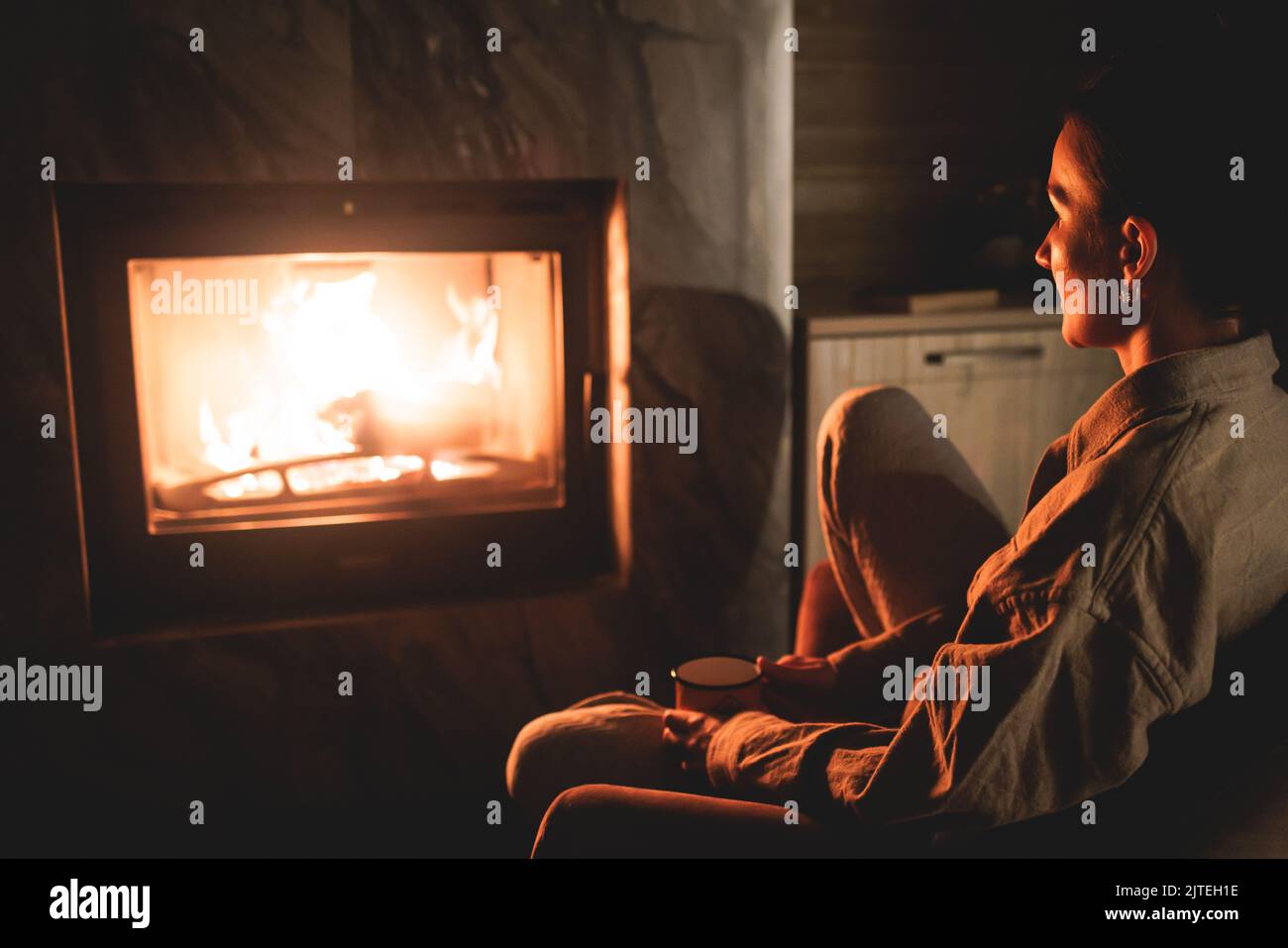 Cozy night in the cabin by the fireplace, fireplace burns in the ...