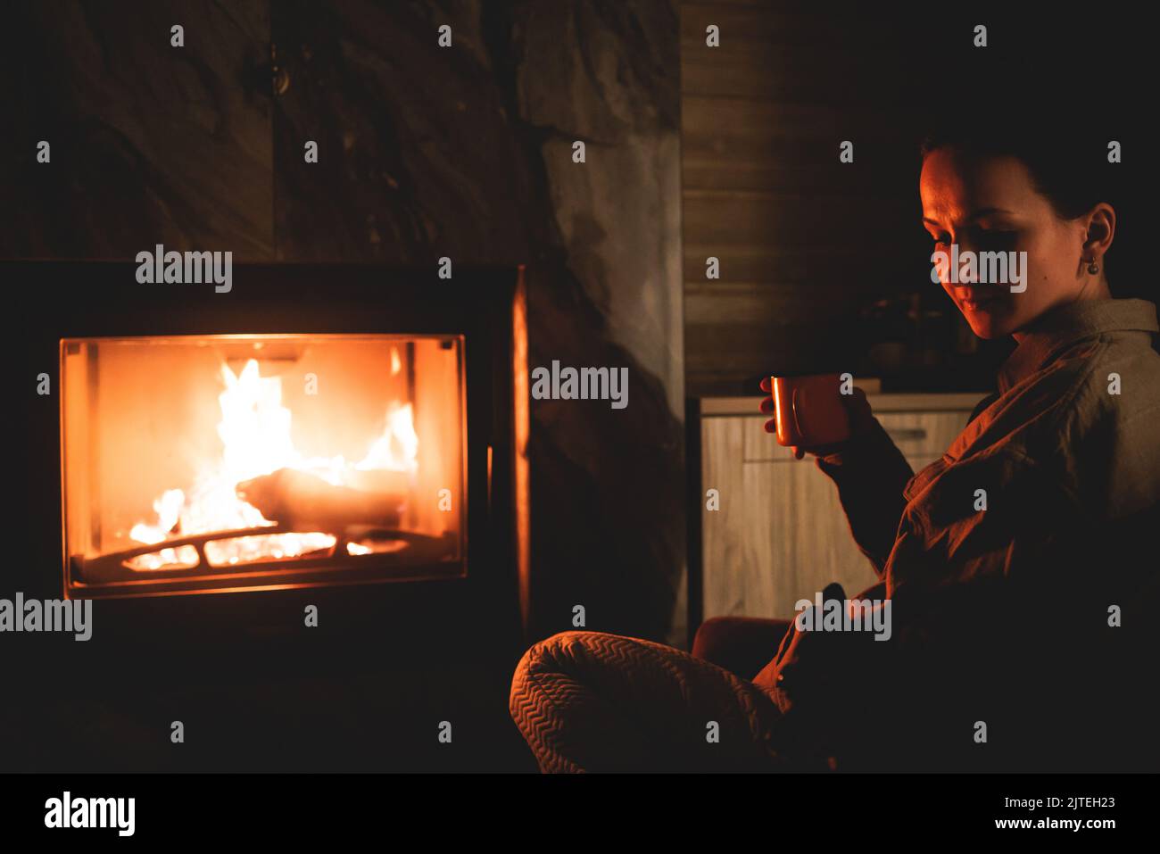 Cozy night in the cabin by the fireplace, fireplace burns in the ...